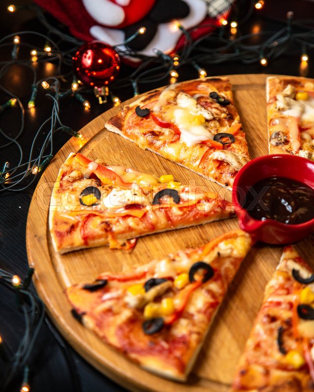 Sliced chicken pizza served with sauce | Stock image | Colourbox