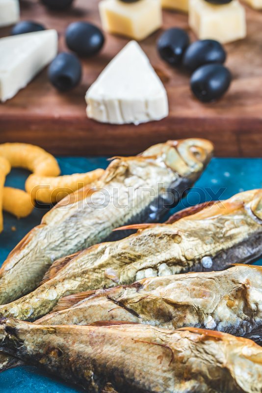 Dry fish snacks servd with cheese and ... | Stock image | Colourbox