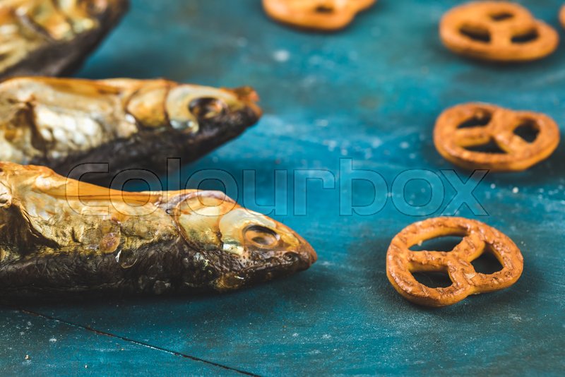 Dried fish snacks on the blue ... | Stock image | Colourbox