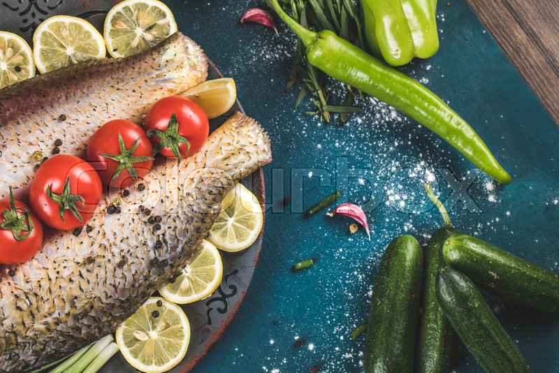 Raw fish ready for cooking with herbs, ... | Stock image | Colourbox