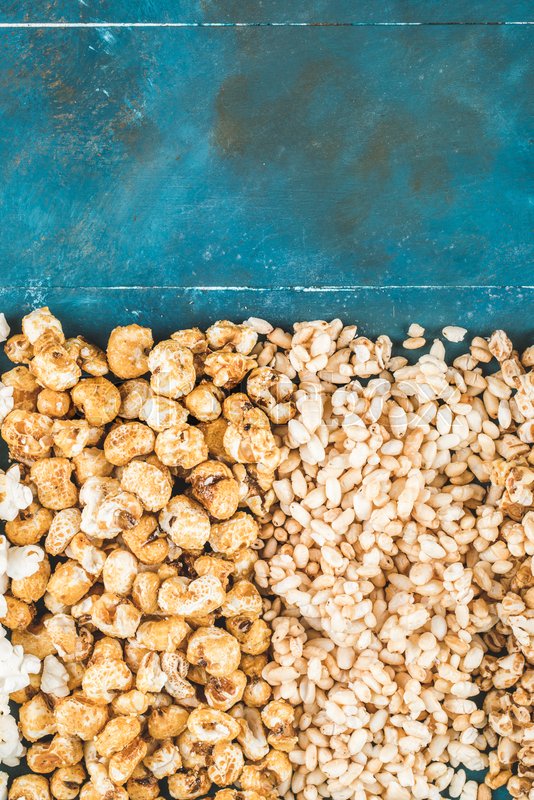 Popcorn and wheat corns on a blue ... | Stock image | Colourbox
