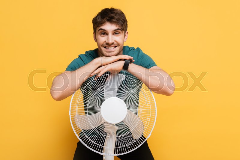 Smiling young man standing with ... | Stock image | Colourbox