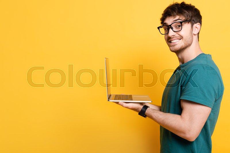 Smiling young man looking at camera ... | Stock image | Colourbox