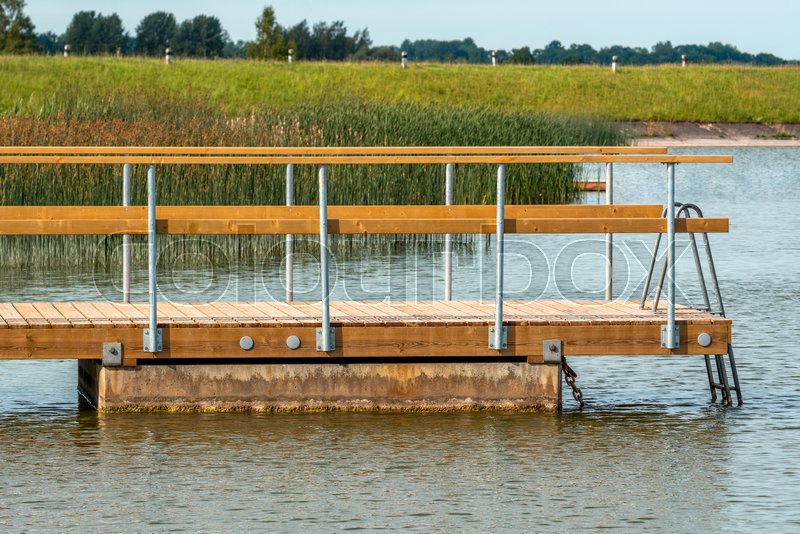 Side view of a wooden pier in a lake | Stock image | Colourbox