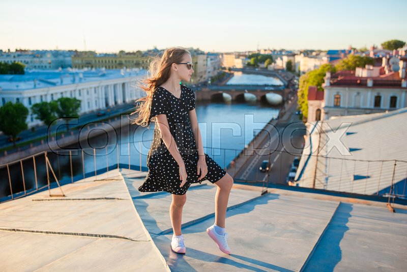 Cute girl on rooftop enjoying with view ... | Stock image | Colourbox