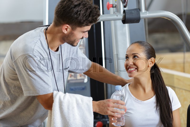 Young people talking in a gym while ... | Stock image | Colourbox