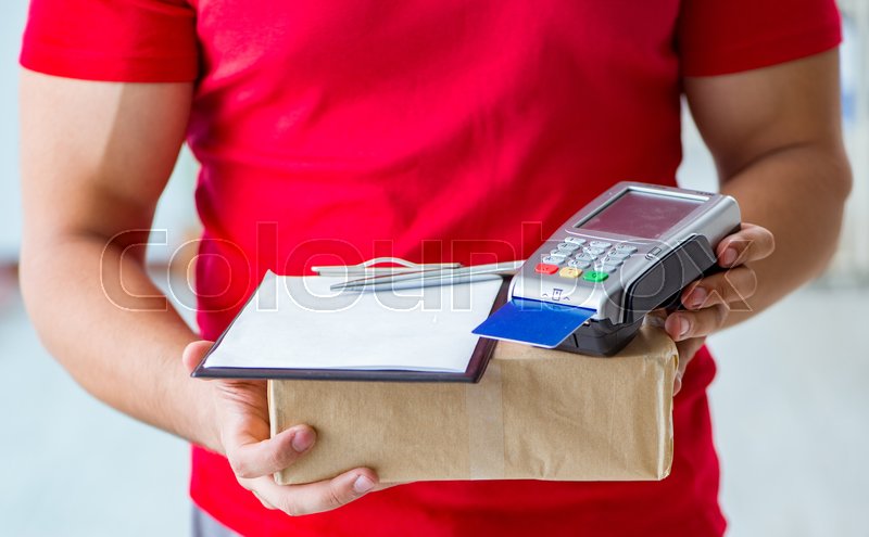 The parcel delivery being paid with pos ... | Stock image | Colourbox