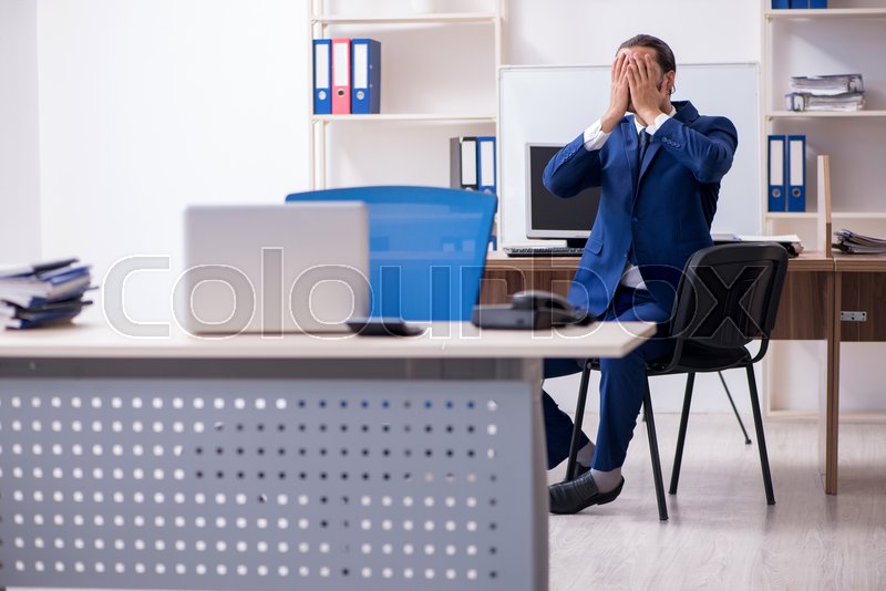 The young male businessman working in ... | Stock image | Colourbox