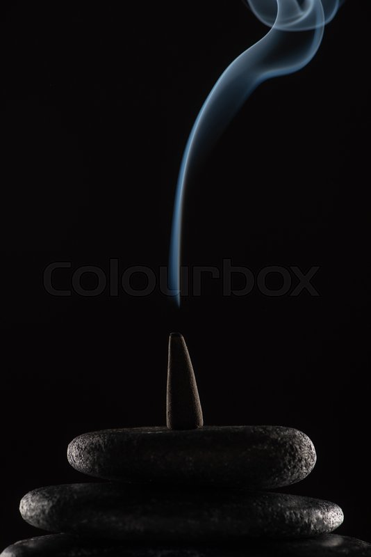 Burning incense cone with smoke on ... | Stock image | Colourbox