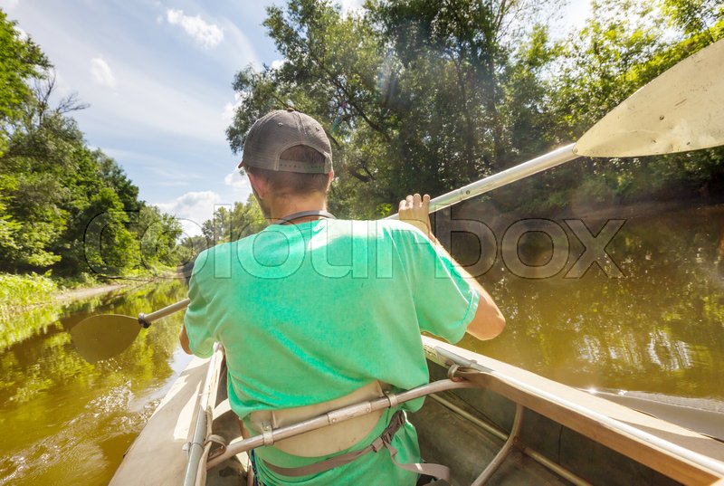 Rear view of kayaker man paddle kayak ... | Stock image | Colourbox