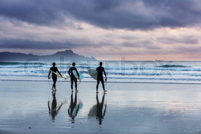 Surfers on ocean beach in New Zealand | Stock image | Colourbox