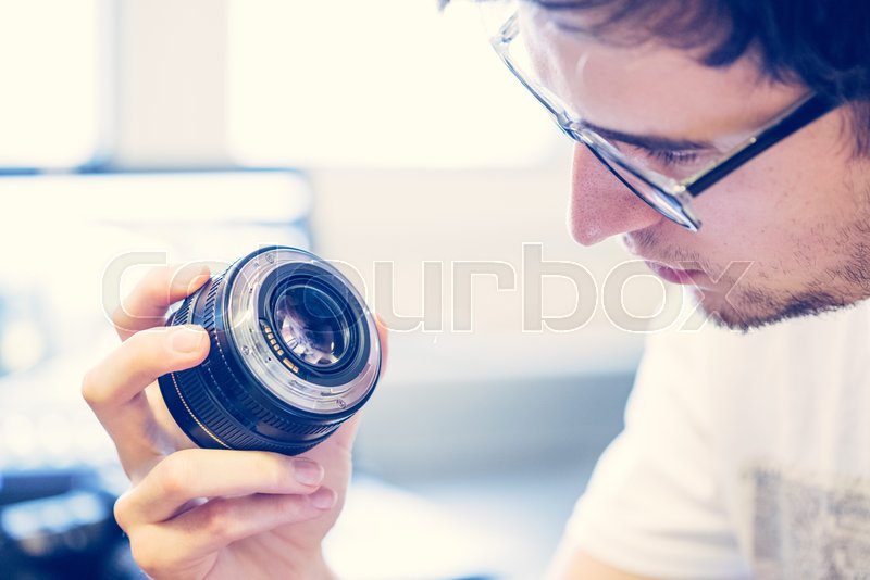 Male photographer has a lens in his ... | Stock image | Colourbox