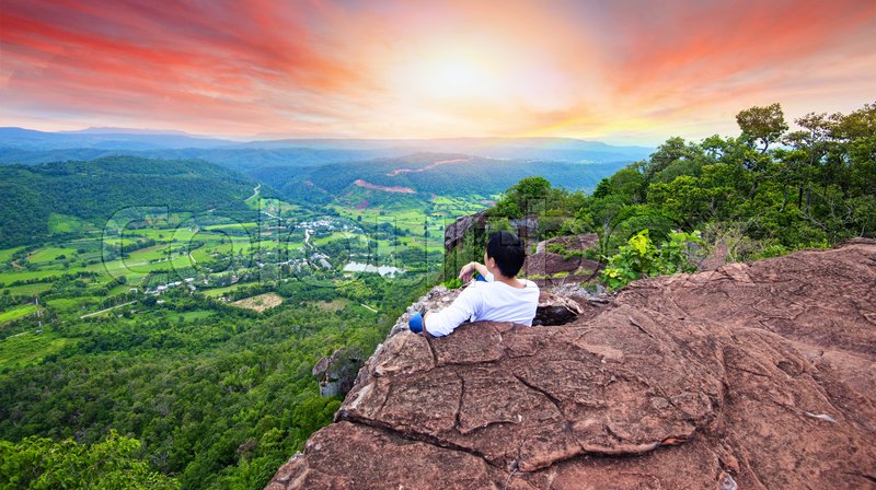 Man on mountain / Hiker sitting on the ... | Stock image | Colourbox