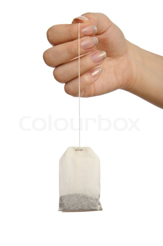 Hand holding teabag on white | Stock Photo | Colourbox