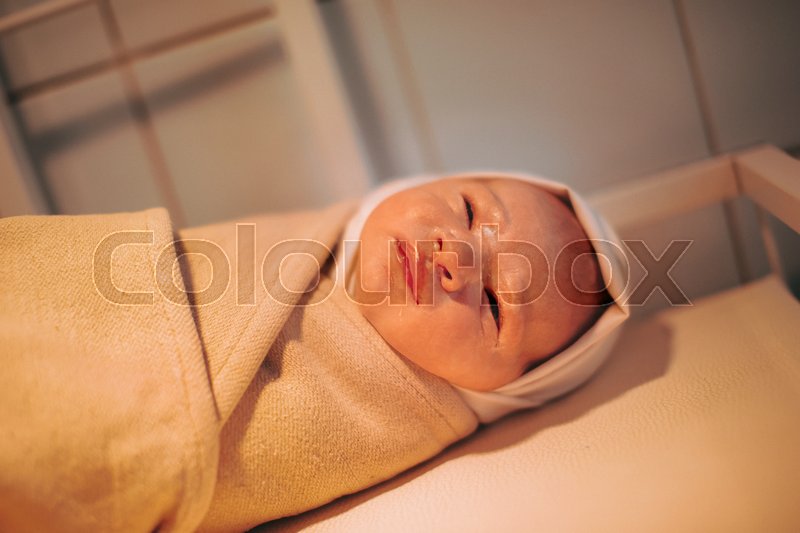 A newborn baby wrapped up after birth ... | Stock image | Colourbox
