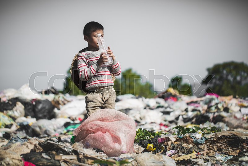 A poor boy collecting garbage waste ... | Stock image | Colourbox