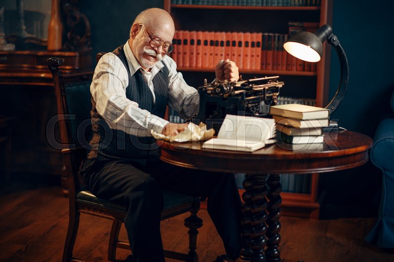 Elderly writer crumples paper at ... | Stock image | Colourbox