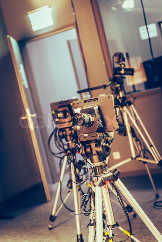Modern film camera on a tripod in a ... | Stock image | Colourbox