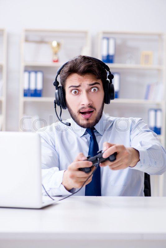 Businessman gamer in office playing ... | Stock image | Colourbox