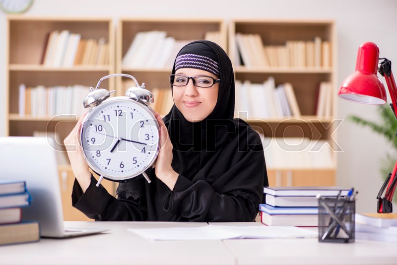 Muslim girl in hijab studying preparing ... | Stock image | Colourbox