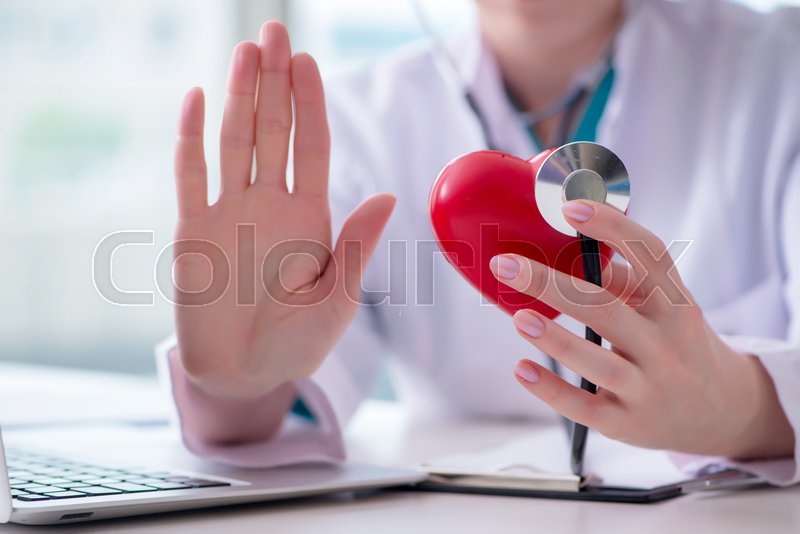 Doctor checking up heart in medical ... | Stock image | Colourbox