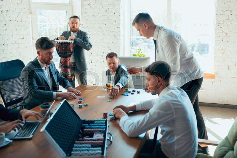 Playing poker, gambling on workplace. ... | Stock image | Colourbox