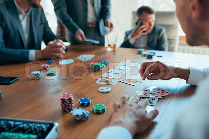 Playing poker, gambling on workplace. ... | Stock image | Colourbox