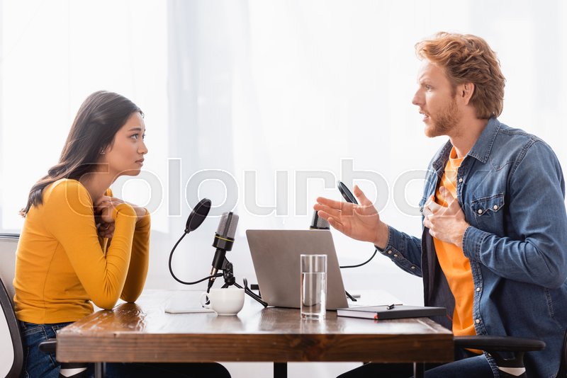 Side view of interviewer gesturing ... | Stock image | Colourbox