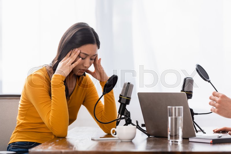 Interviewer near upset asian woman with ... | Stock image | Colourbox