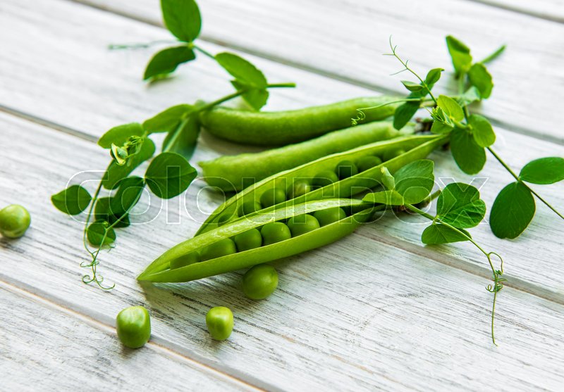 Pods of green peas with pea leaves on ... | Stock image | Colourbox