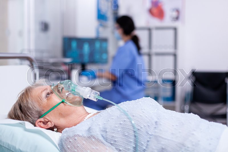 Senior woman breathing through oxygen ... | Stock image | Colourbox