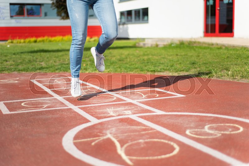 Girl Jumping while Playing Hopscotch at ... | Stock image | Colourbox