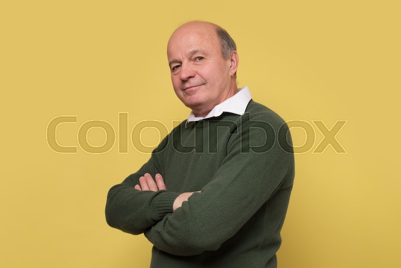 Elegant senior bald man smiling ... | Stock image | Colourbox