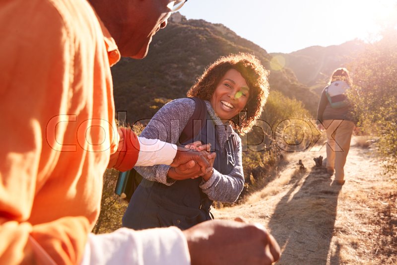 Woman Helping Man On Trail As Group Of ... | Stock image | Colourbox