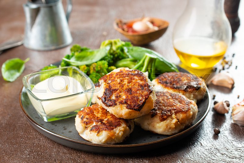 Fish cutlet with white sauce on plate | Stock image | Colourbox