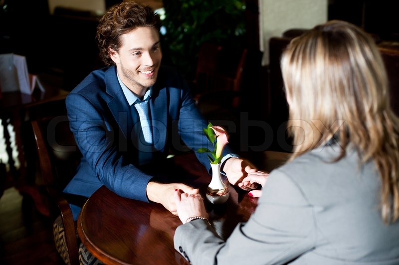 Romantic couple sitting across the ... | Stock image | Colourbox