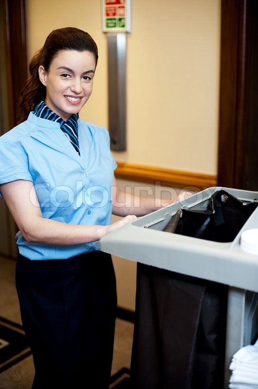 Female attendant posing with cart | Stock Photo | Colourbox