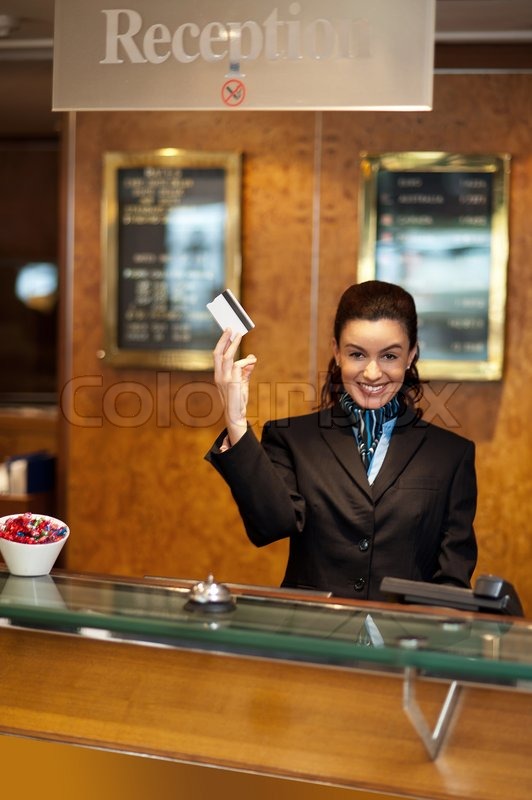 Beautiful receptionist posing with ... | Stock image | Colourbox