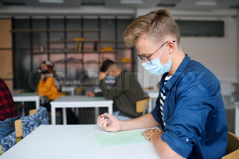 Side view of young student with face ... | Stock image | Colourbox
