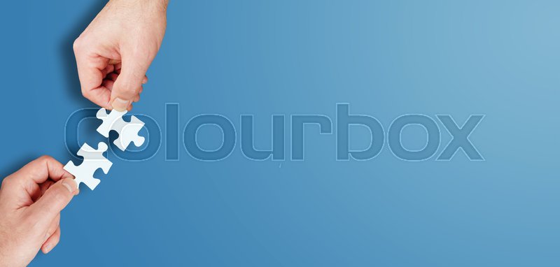 Hands of two people putting together ... | Stock image | Colourbox