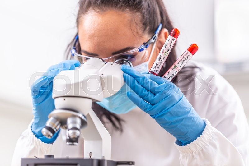 Laboratory worker looks into the ... | Stock image | Colourbox