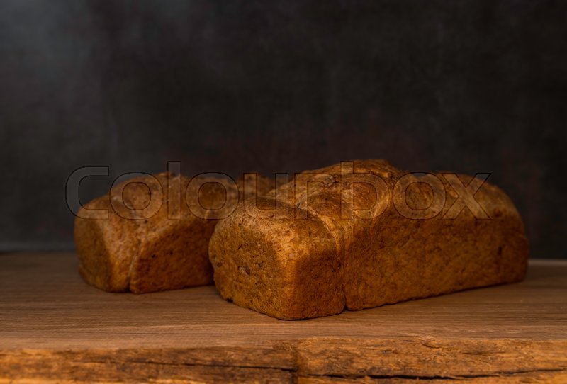 Freshly baked bread on a wooden board | Stock image | Colourbox