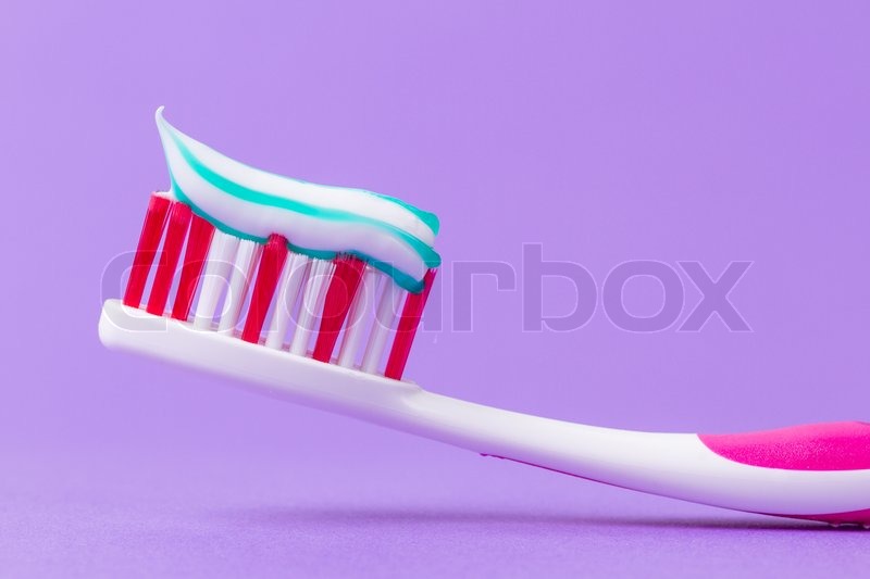 A pink toothbrush with toothpaste | Stock image | Colourbox