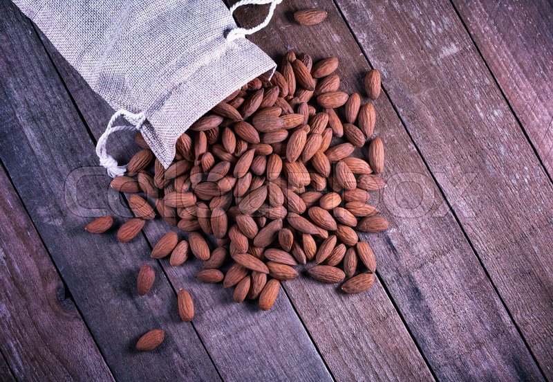 A lot of almonds falling from inside ... | Stock image | Colourbox