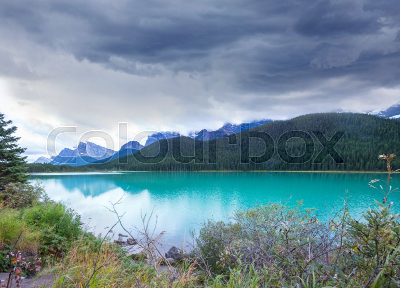 Serene scene by the mountain lake in ... | Stock image | Colourbox