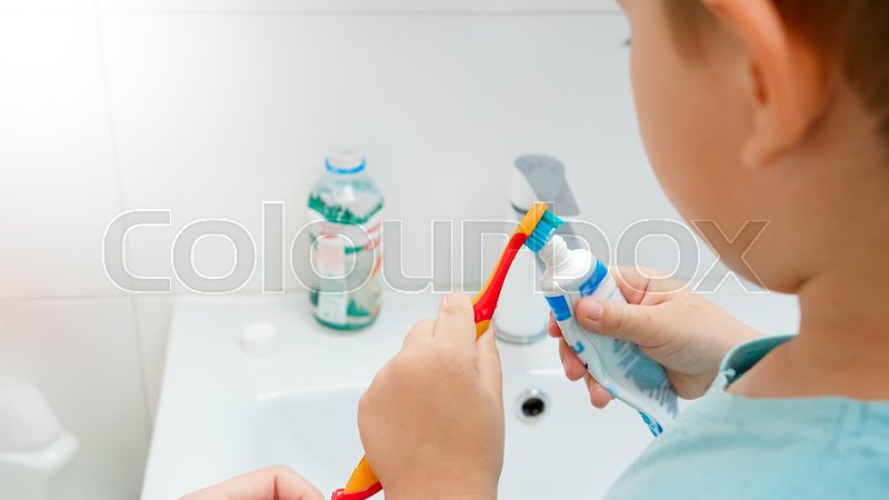 Little boy applying toothpaste on ... | Stock image | Colourbox