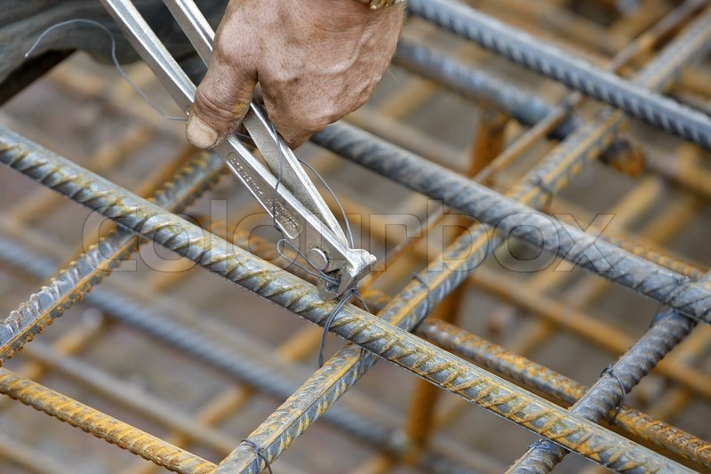 Hand of a steel bender with a pair of ... | Stock image | Colourbox
