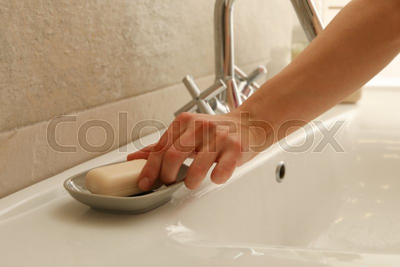 Woman takes soap from soap dish in ... | Stock image | Colourbox