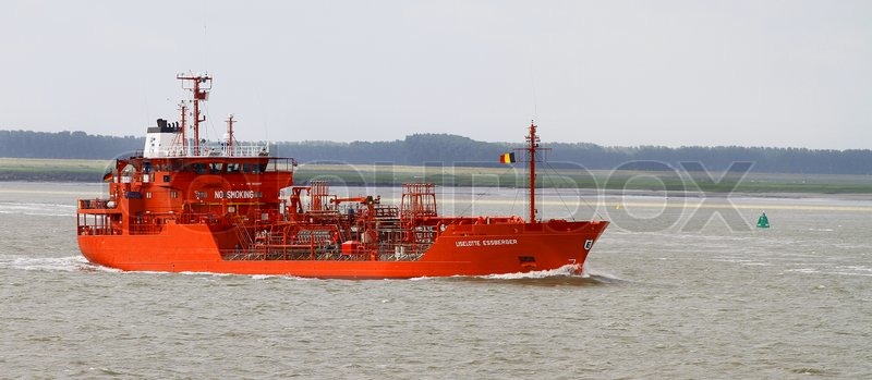 Small oil tanker in a river | Stock image | Colourbox