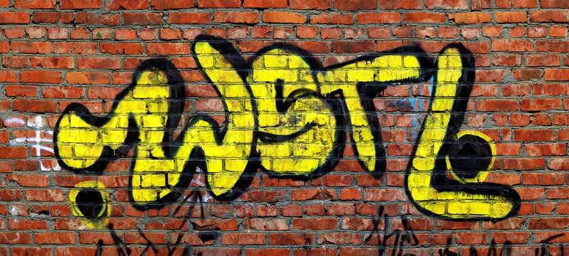 Yellow graffiti on red brick wall | Stock Photo | Colourbox